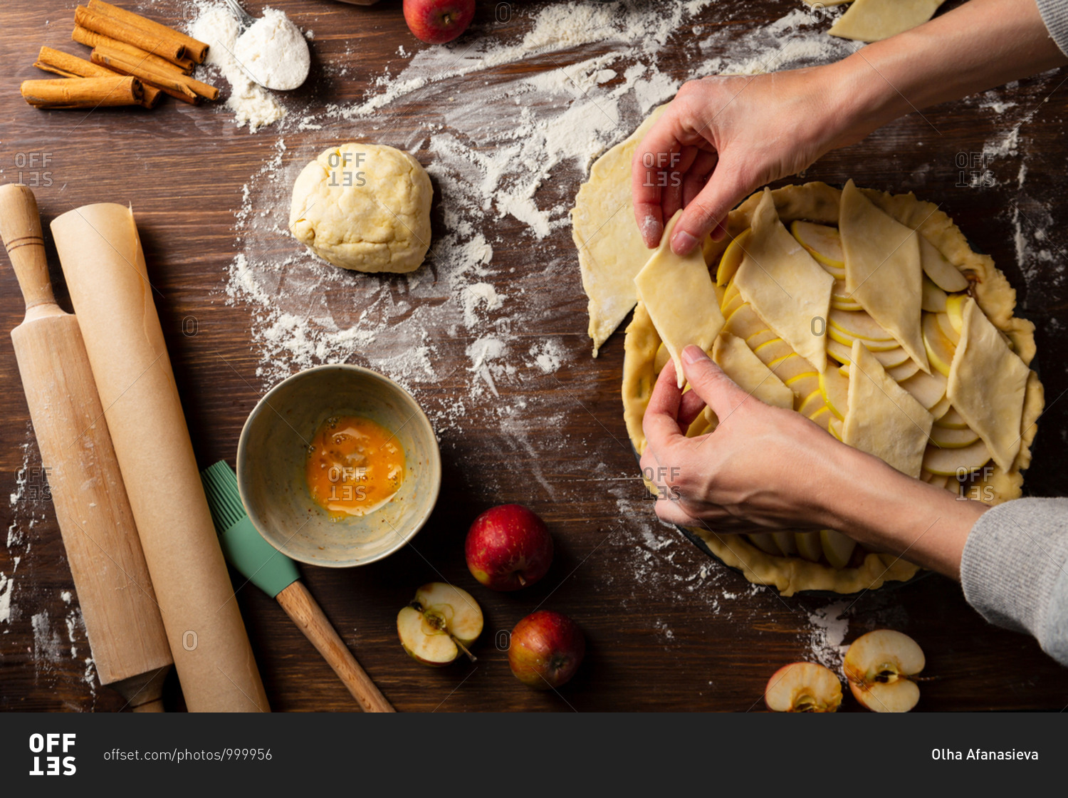 Hands placing raw dough for crust on top of apple pie - Stock Image ...