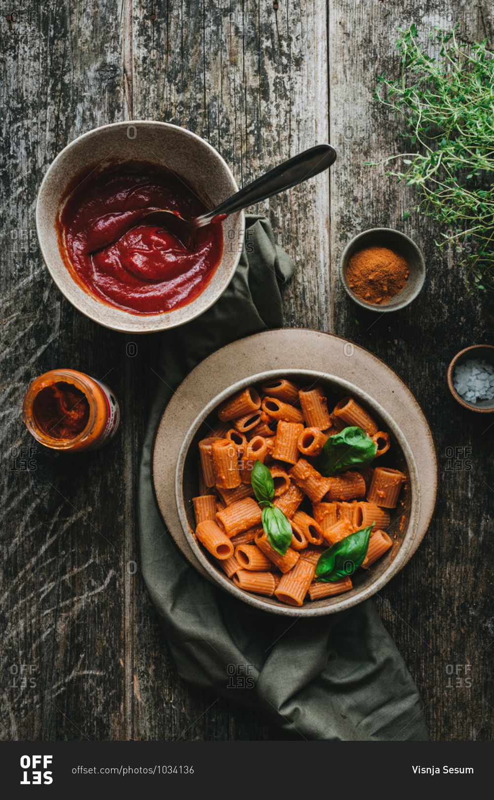 Rigatoni pasta with red pesto sauce and basil - Stock Image - Everypixel