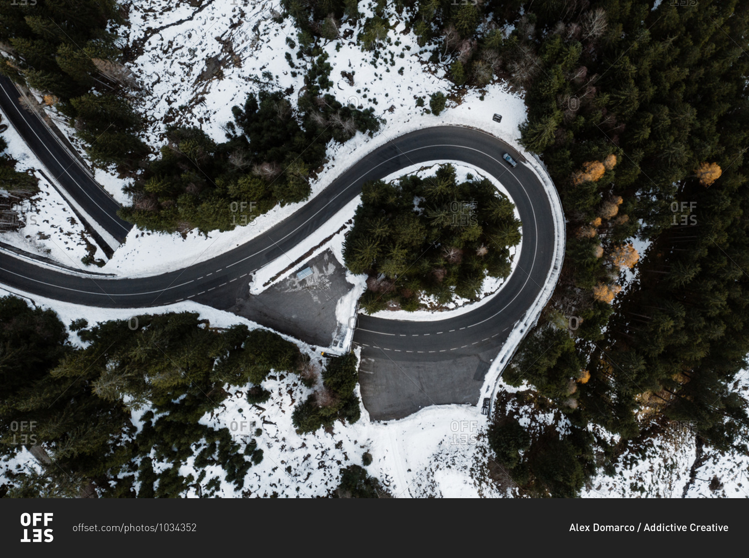 Spectacular drone view of lonely car on road junction in coniferous ...