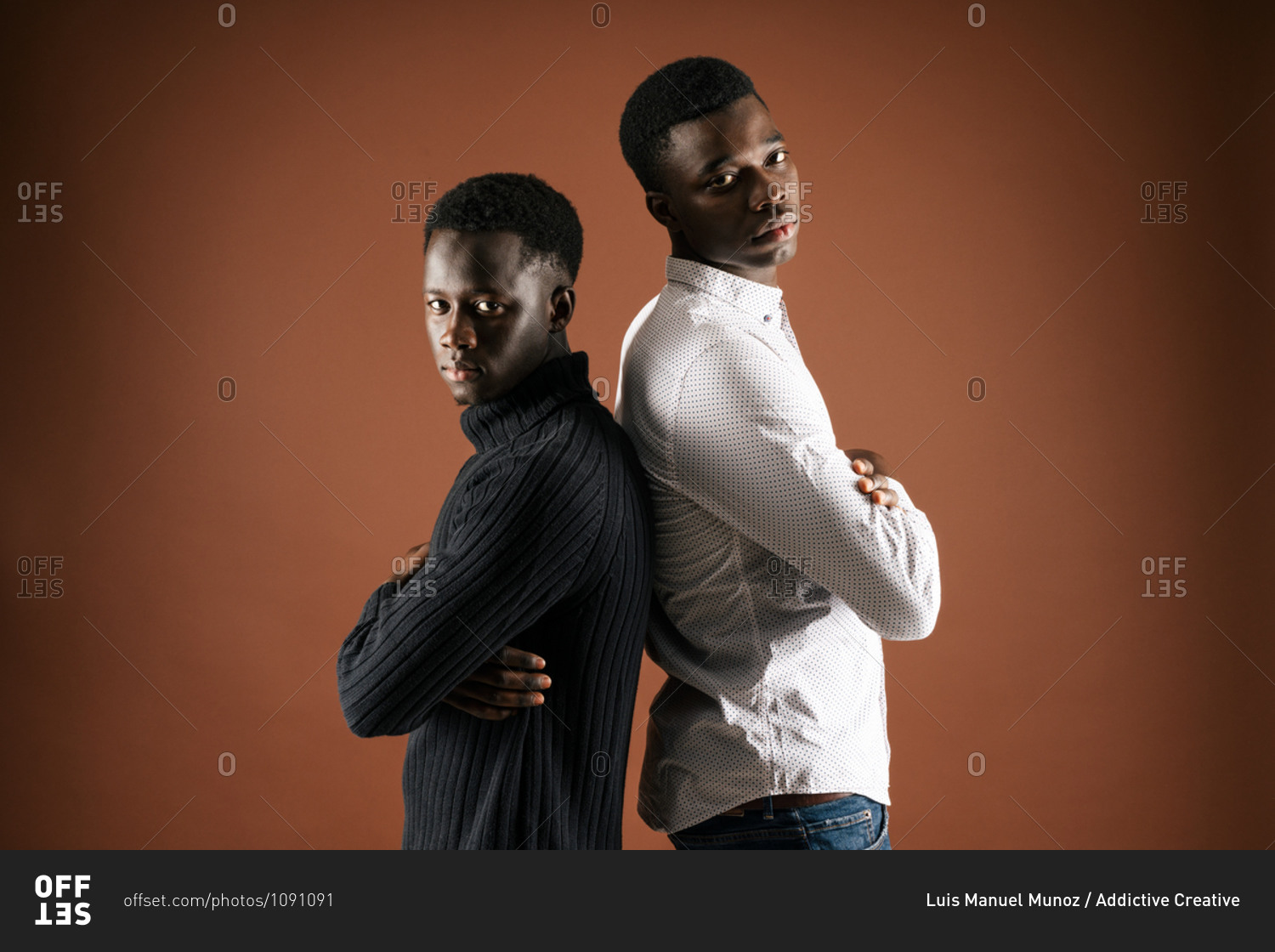 Two Men Standing Back To Back