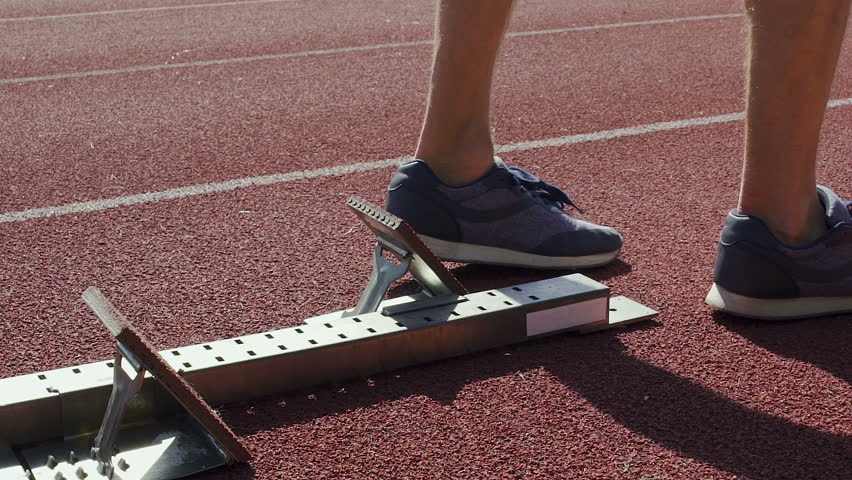 lean runner beginning race starting blocks Stock Footage Video (100% ...