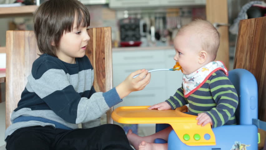 cute preschool boy feeding his baby Stock Footage Video (100% Royalty ...