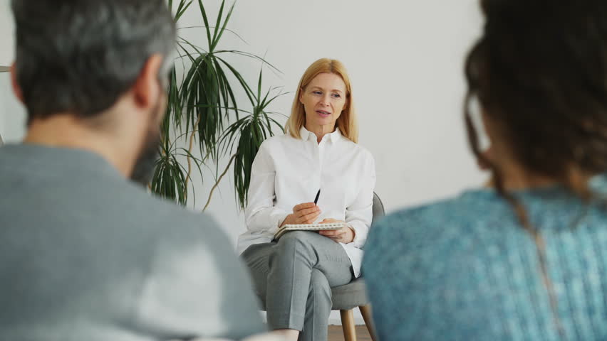 female experienced psychoanalyst talking married couple Stock Footage ...
