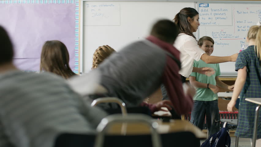 frustrated teacher scolding children chaotic classroom Stock Footage ...