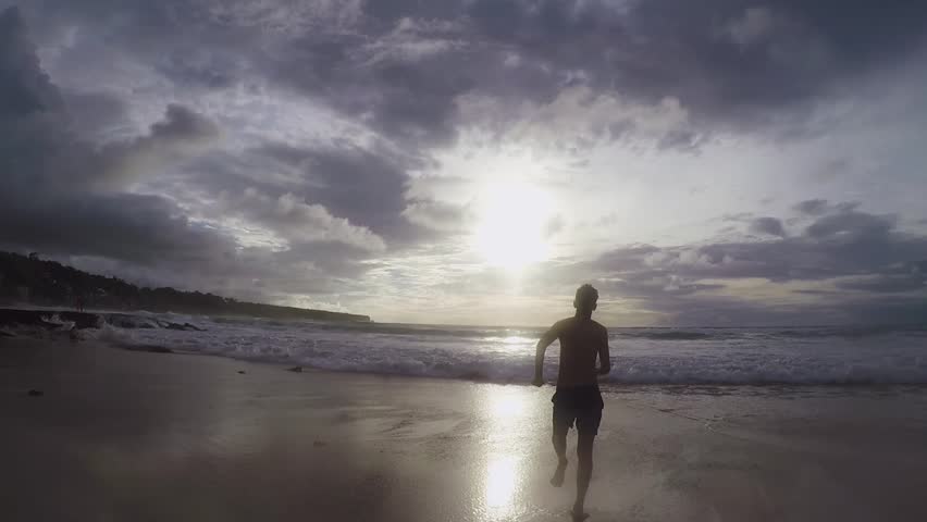 silhouette man running into ocean sunset Stock Footage Video (100% ...