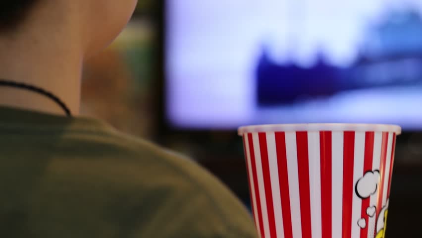 eating popcorn while watching movie on Stock Footage Video (100% ...