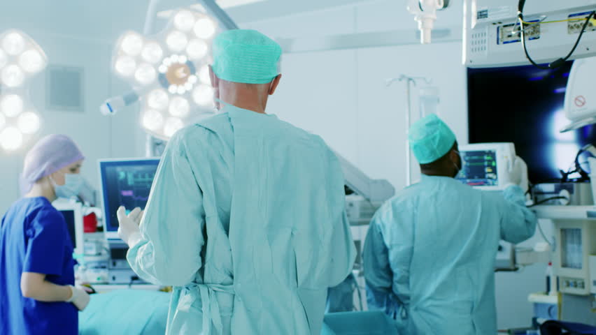 senior surgeon enters operating room where Stock Footage Video (100% ...