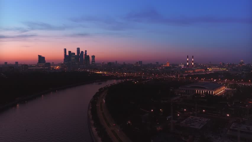 Aerial flight shot above russian night city lights. Cold evening winter ...