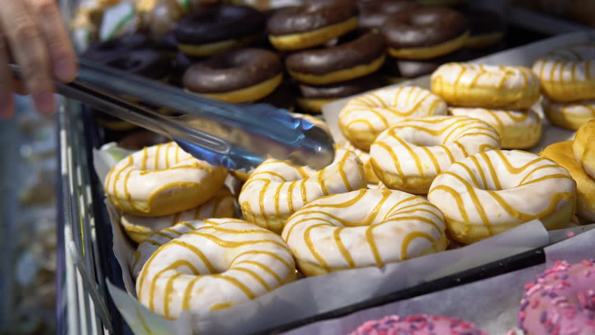 someone using tongs takes donut white Stock Footage Video (100% Royalty ...