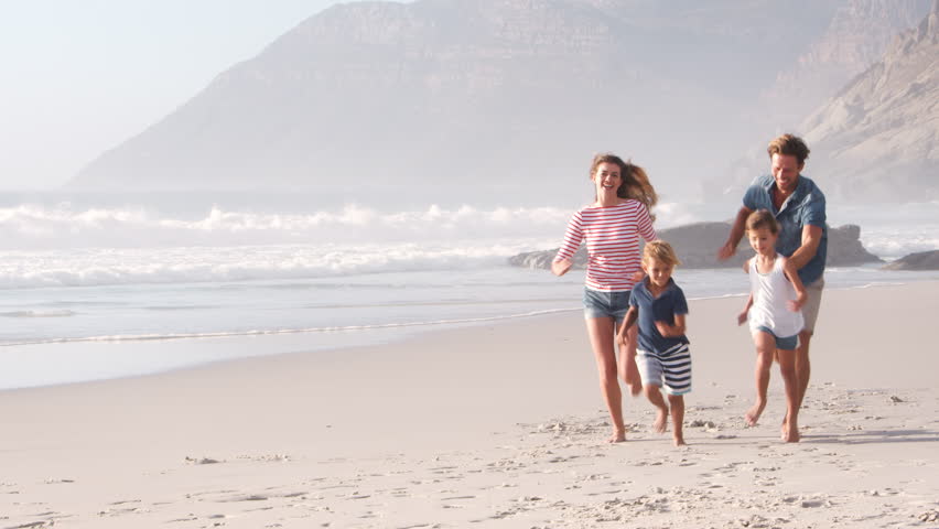 parents chasing children along beach on Stock Footage Video (100% ...