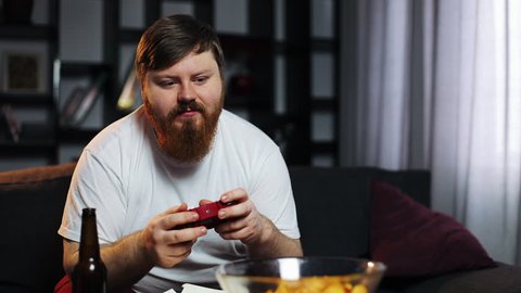 Fat man playing video games Stock Video Footage - 4K and HD Video Clips ...