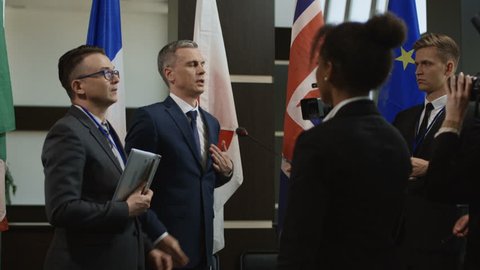 Formal Representative Standing Against International Flags Stock ...