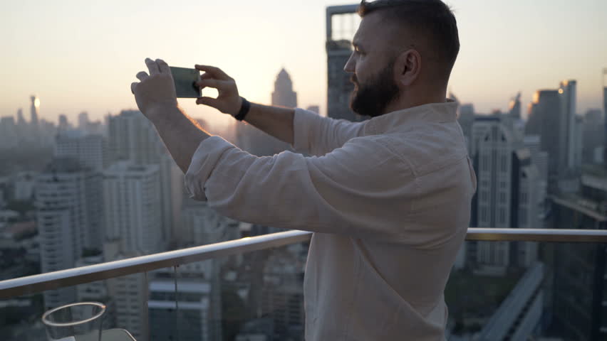 man standing on rooftop during sunset Stock Footage Video (100% Royalty ...