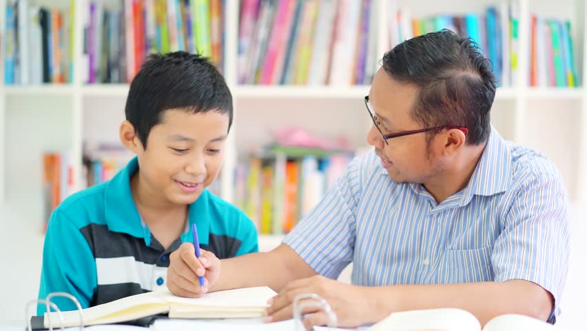 student teacher reading book together classroom Stock Footage Video ...