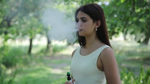 Young Beautiful Girl Vaping Ecigarette Park Stock Footage Video (100% ...