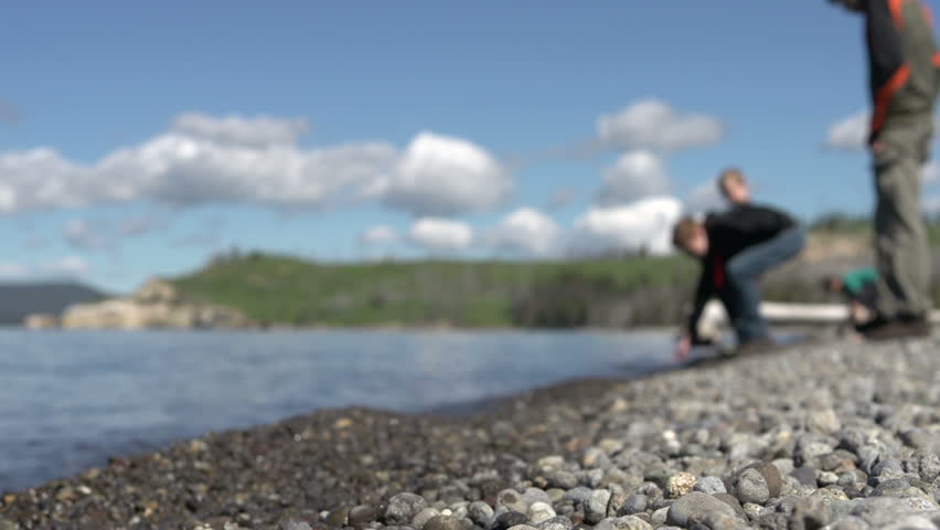 kids collecting rocks skip on lake Stock Footage Video (100% Royalty ...