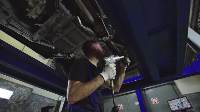 Auto Mechanics Working Under the Stock Footage Video (100% Royalty-free ...