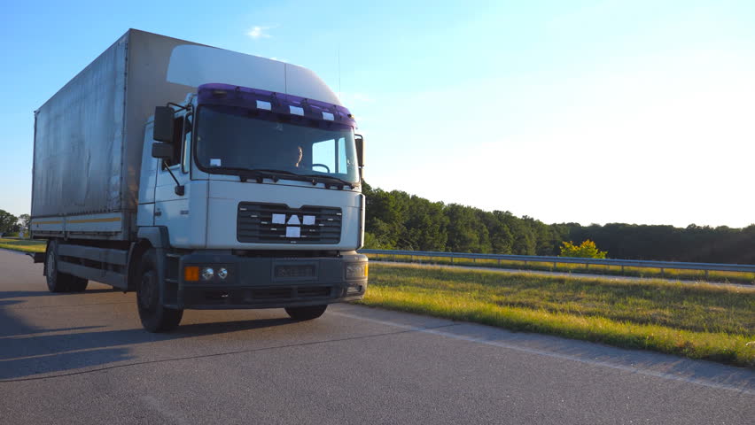 front-view camera follows semi-truck cargo trailer Stock Footage Video ...