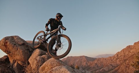 Cyclist Riding Bike Down Rock Sunrise Stock Photo (Edit Now) 1714931941