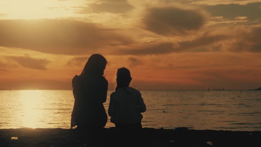 Silhouettes Mother Daughter Sit On Beach Stock Footage Video 100