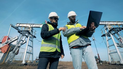 Two Men Working Near Oil Towers Stock Footage Video (100% Royalty-free ...