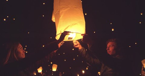 Happy Young Couple Releasing Flaming Lantern Stock Footage Video (100% ...