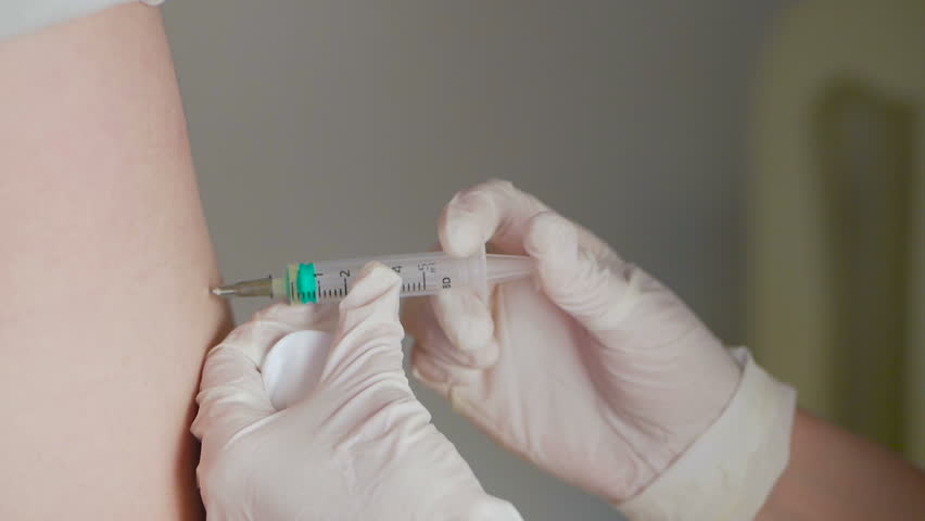 close-up hand medic administering intramuscular injection Stock Footage ...