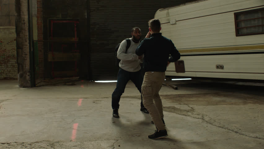 two men angrily fight over backpack Stock Footage Video (100% Royalty ...