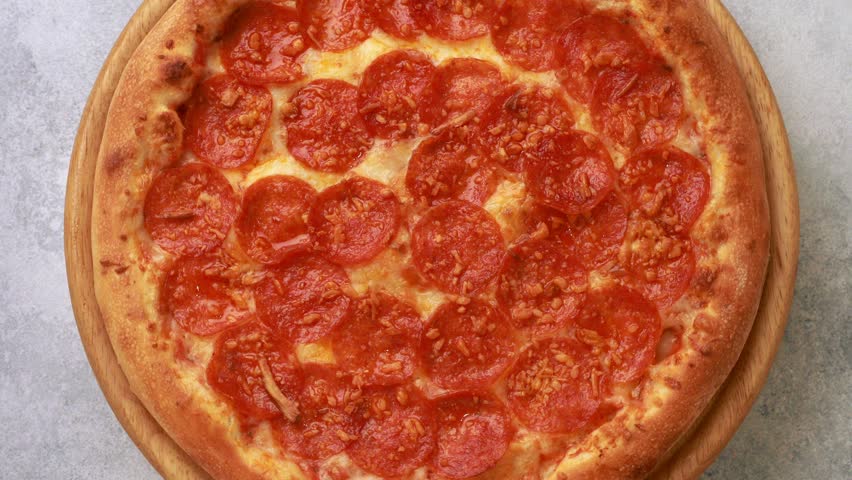 delicious pepperoni pizza spinning on table Stock Footage Video (100% ...