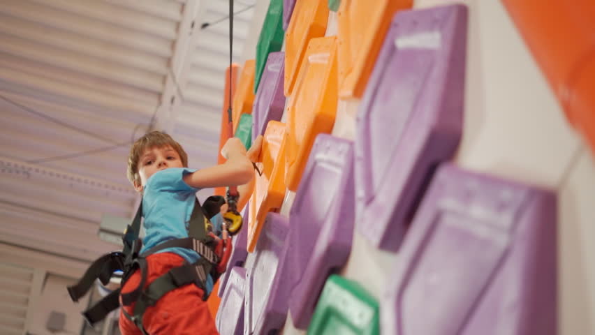 boy climbing challenge on indoor wall Stock Footage Video (100% Royalty ...