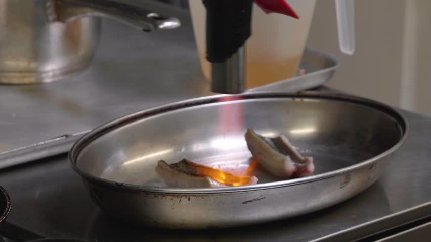 chef using blowtorch on fish pan Stock Footage Video (100% Royalty-free ...