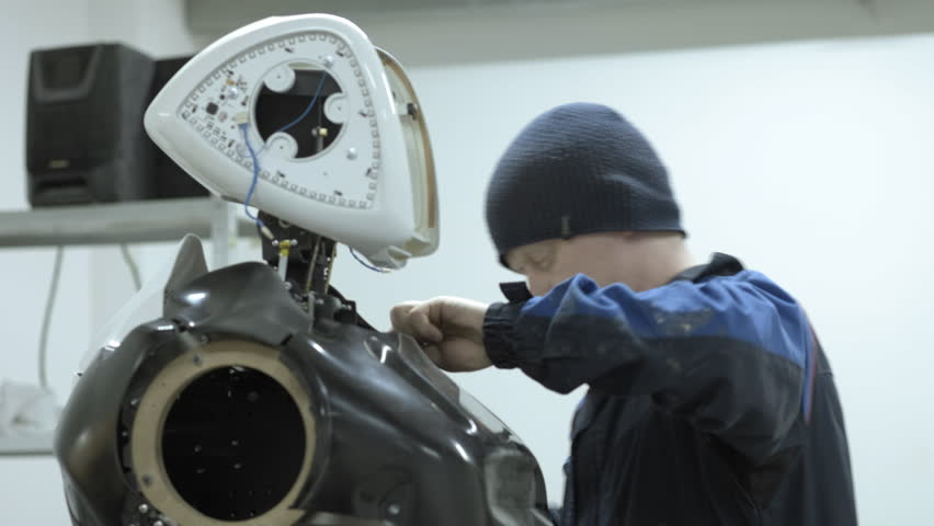 Diverse Team of Industrial Robotics Engineers Gathered Around Table ...