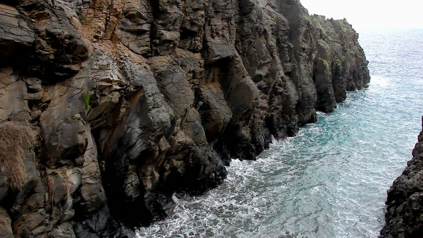 volcanic rock cliff by ocean on Stock Footage Video (100% Royalty-free ...