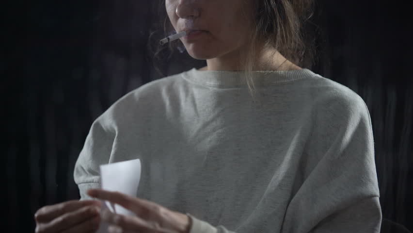 depressed woman smoking cigarette thinking about Stock Footage Video ...