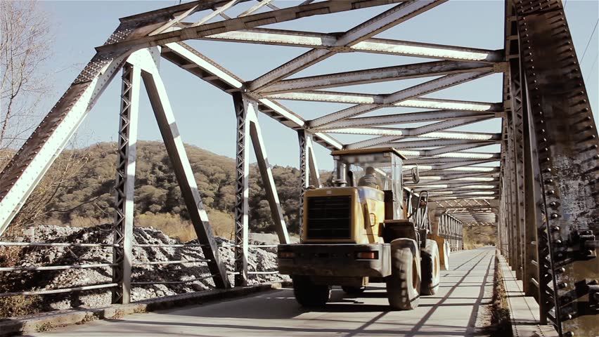 wheel loader crossing old steel bridge Stock Footage Video (100% ...