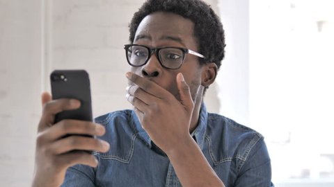 African Man Shock While Using Smartphone Stock Footage Video (100% ...