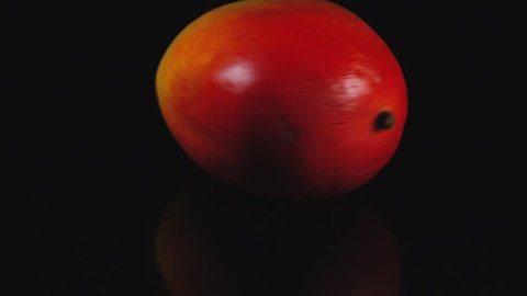 Close Spinning Mango On Black Mirror Stock Footage Video (100% Royalty ...