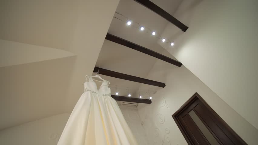 bride's dress hangs under ceiling very Stock Footage Video (100% ...