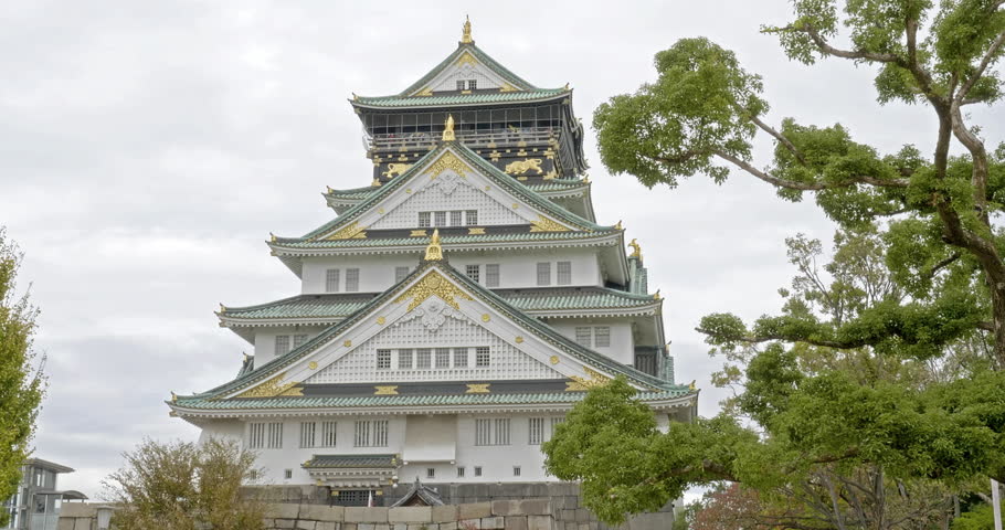 4K, Main tower of Osaka Japanese Castle behind rock wall, famous ...