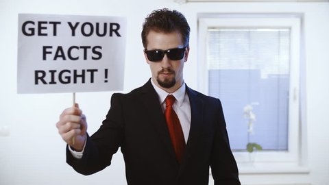 Businessman Hold Sign Get Your Facts Stock Footage Video (100% Royalty ...