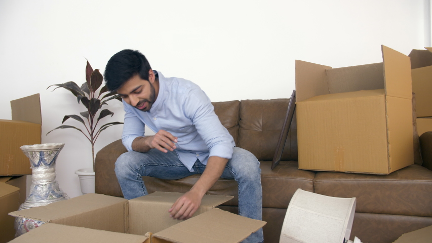 Young Indian Man Unpacking Cartons Stock Footage Video 100 Royalty