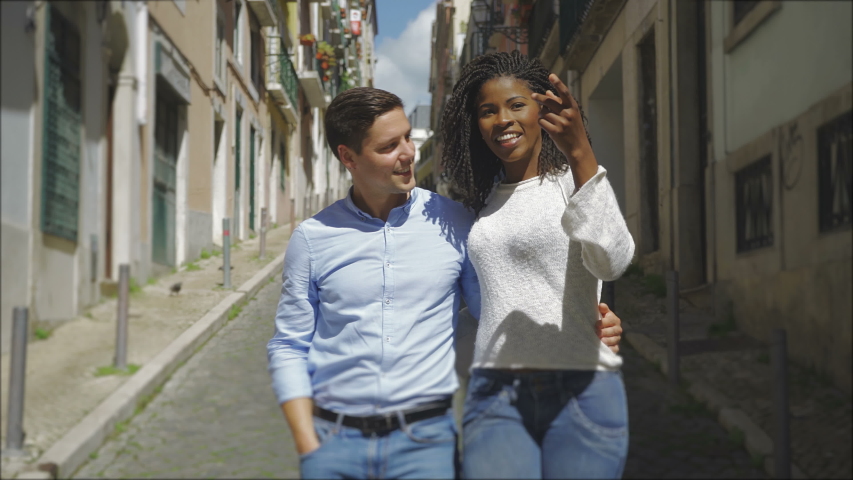 smiling multiracial couple talking while walking Stock Footage Video ...