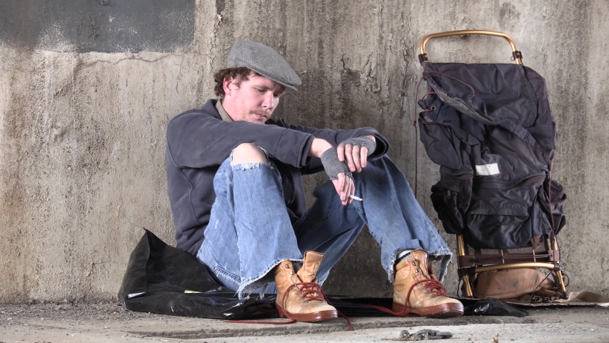 young homeless man smoking cigarette sitting Stock Footage Video (100% ...