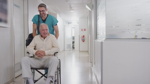 Male Orderly Pushing Senior Male Patient Stock Footage Video (100% ...