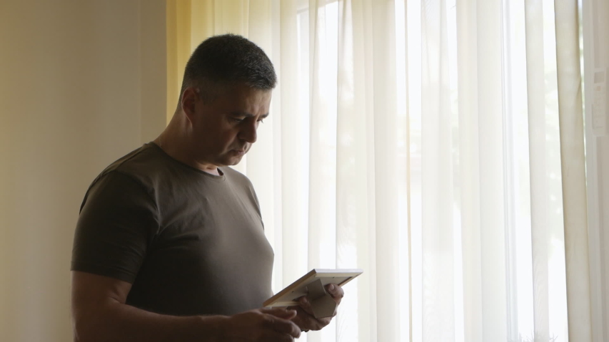 lonely man standing window holding photo Stock Footage Video (100% ...