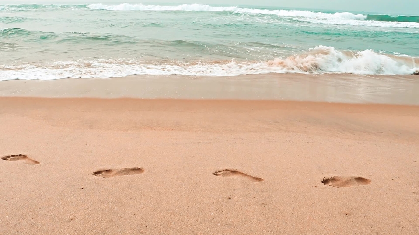 Beach with footsteps in the sand with clouds image - Free stock photo ...