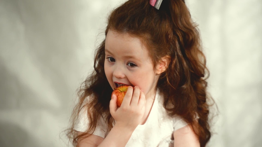 A Little Girl Happily Nibbles Stock Footage Video (100% Royalty-free ...
