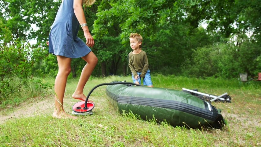 woman pumping inflatable boat foot pump Stock Footage Video (100% ...