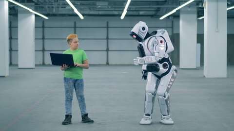 human-like cyborg lifting his arms after Stock Footage Video (100% ...