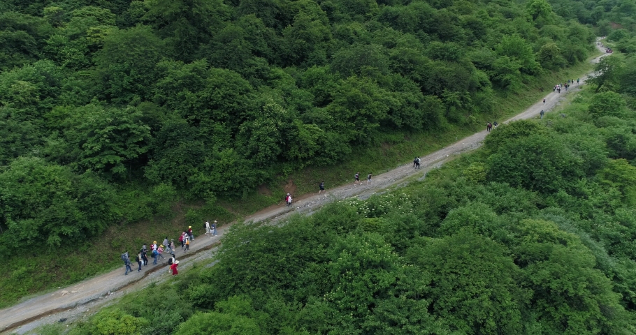 Group of people walking on the path walking in the landscape image ...